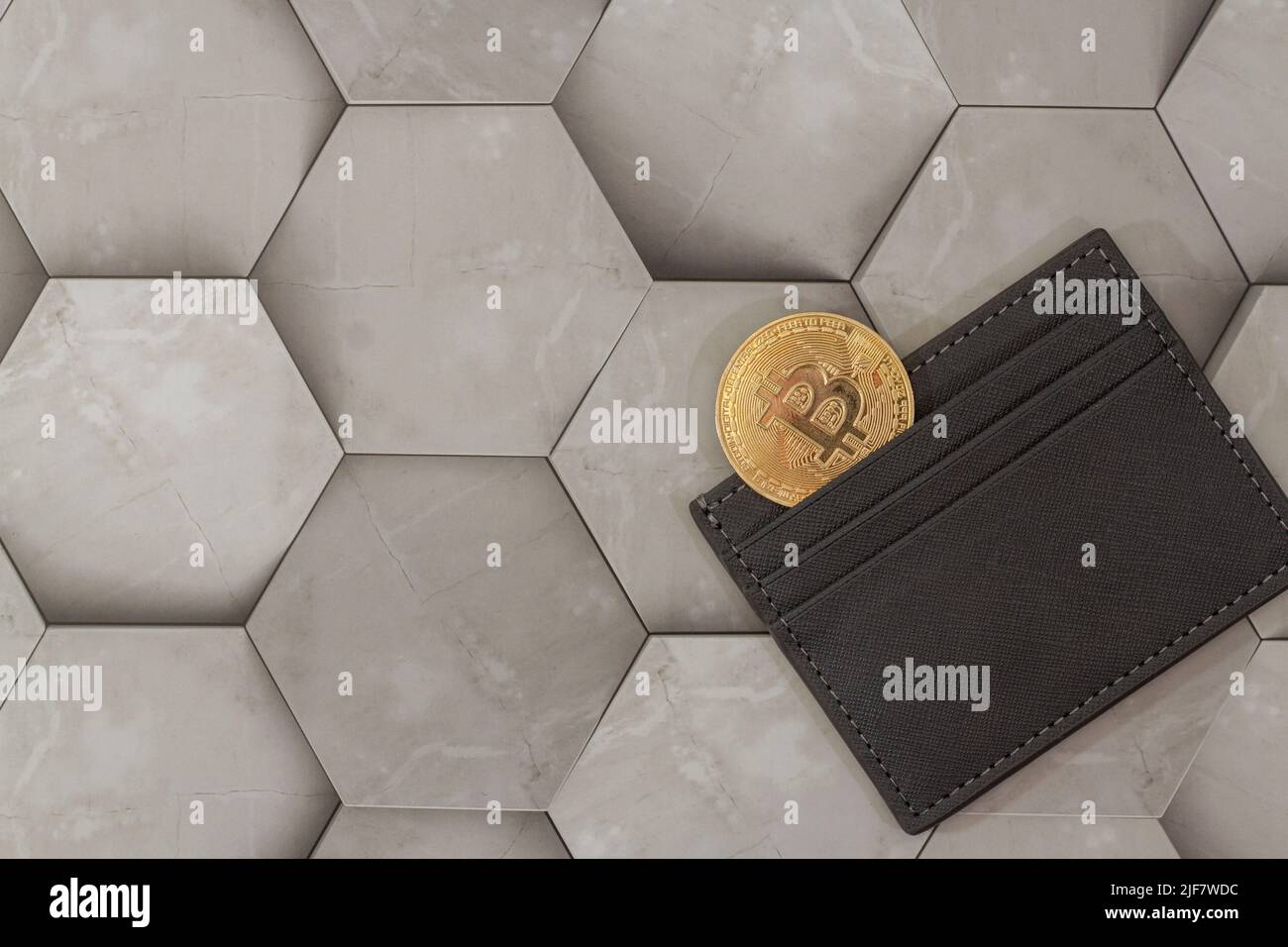 bitcoin gold coin place in wallet on hexagon gray background. Online ...