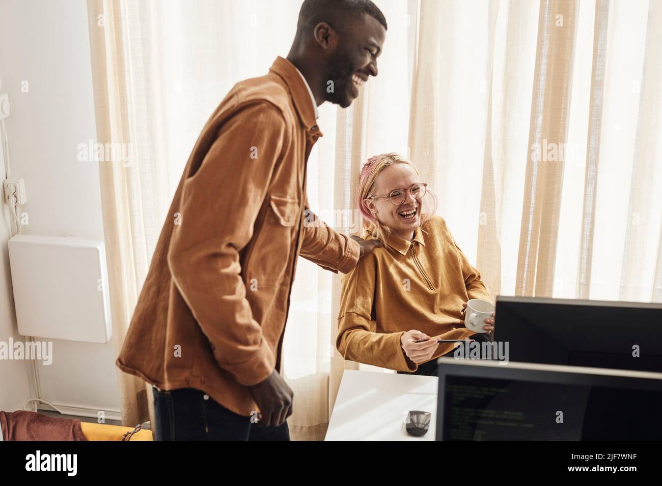 Young IT computer programmers laughing together in office Stock Photo ...