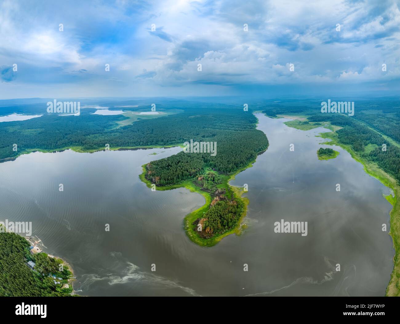 Big lake with green shores in bright sun light, aerial landscape ...