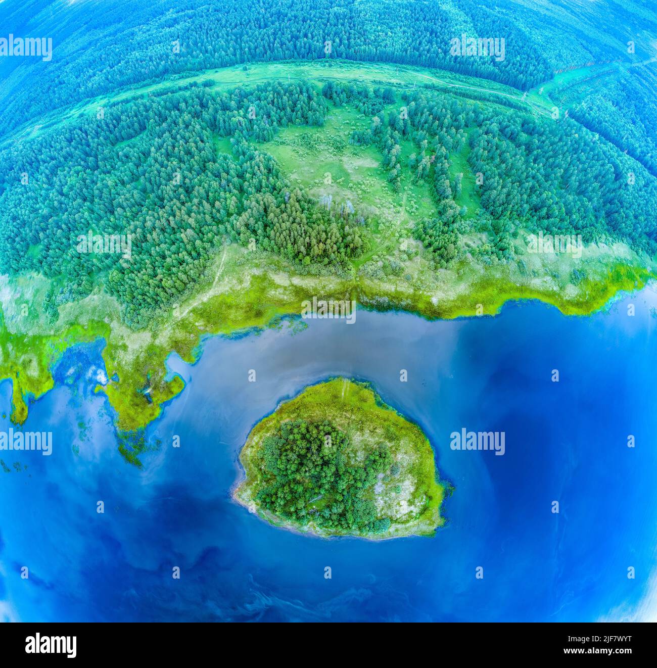 Big lake and island with green shores with morning fog in dawn, aerial ...