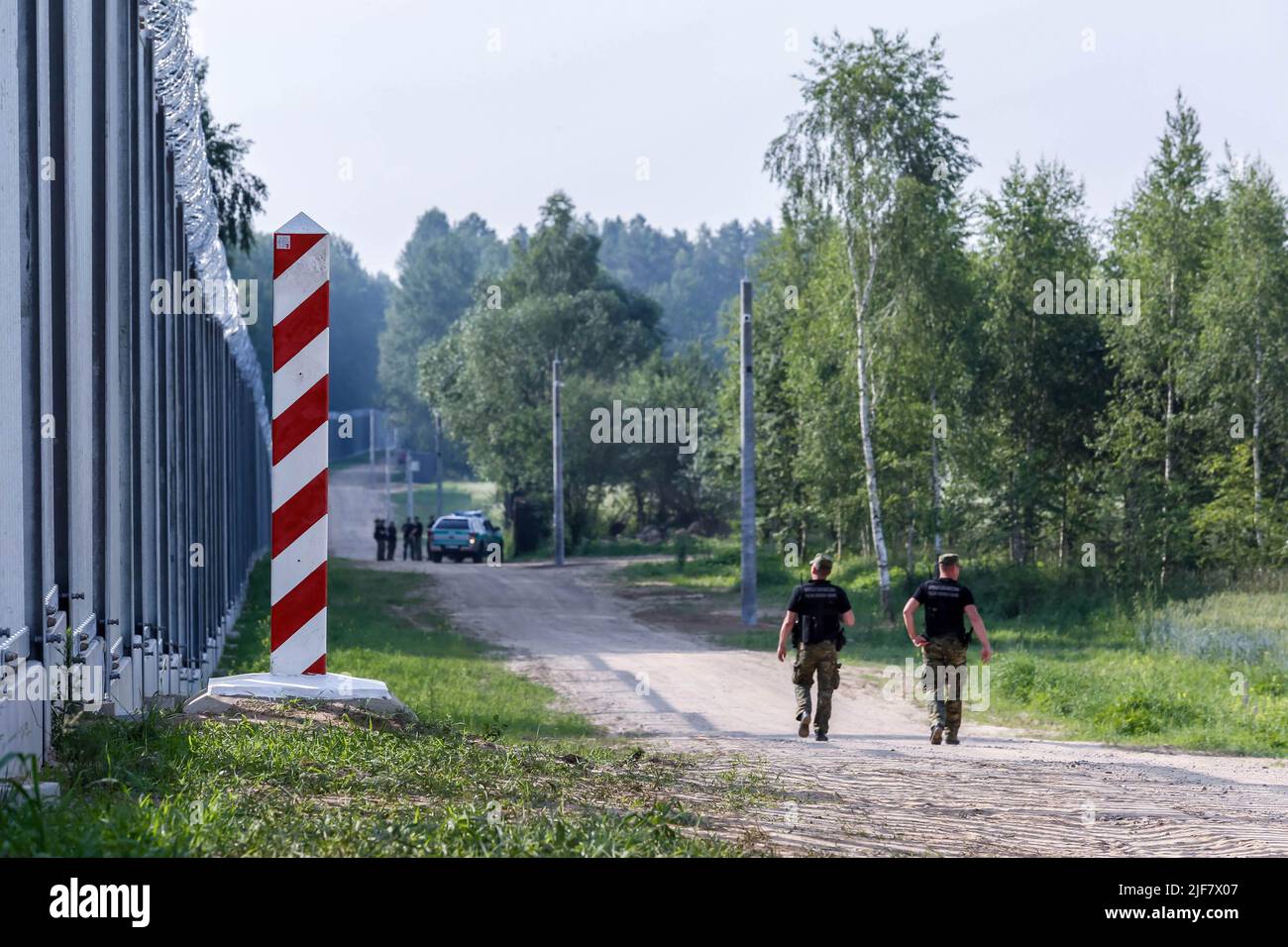 Border guards patrol the physical barriers built on the border between ...