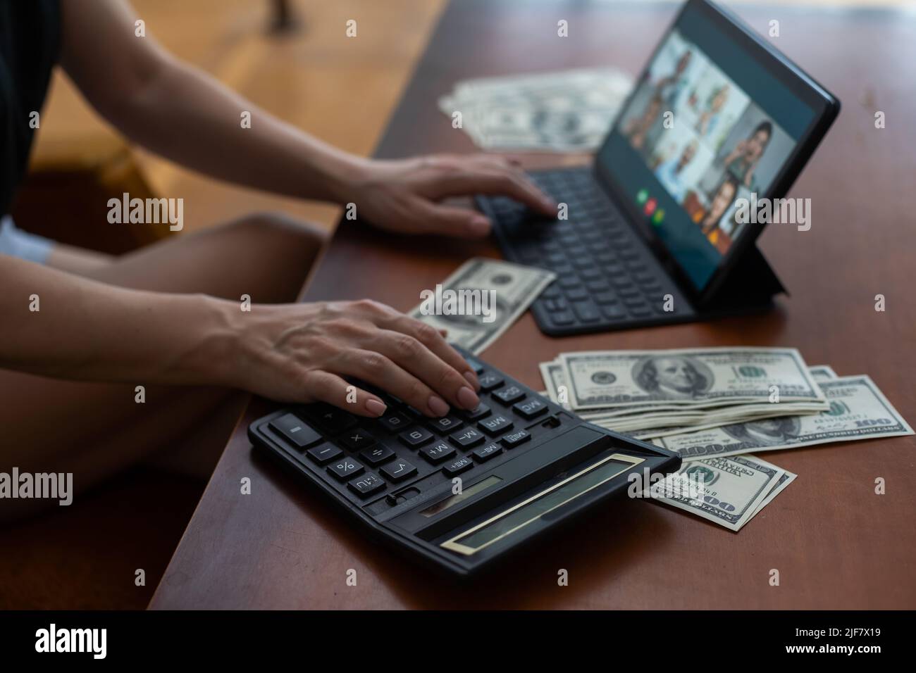 tablet screen and lot of hundred dollar bills. Business and social ...