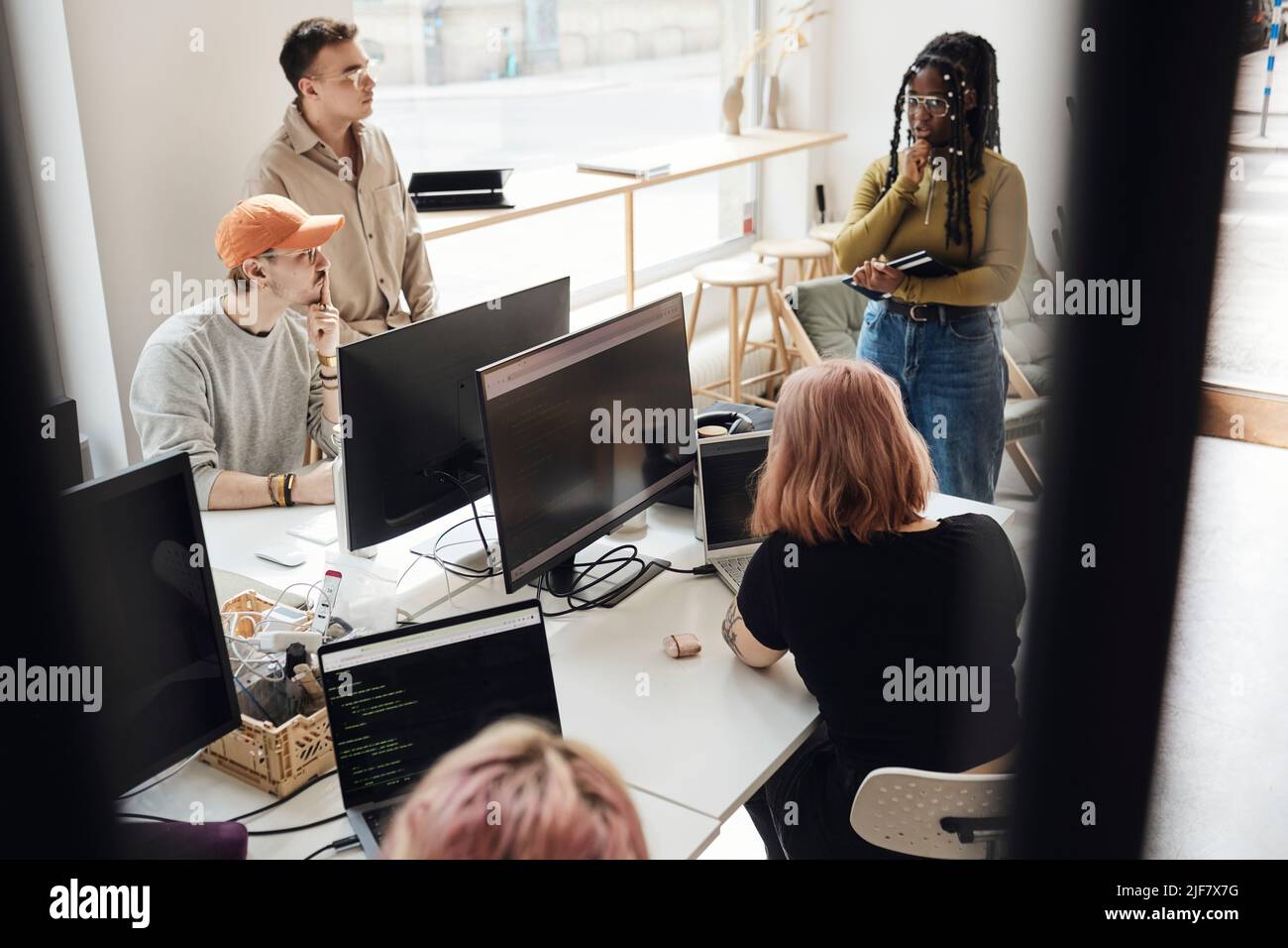 Male and female entrepreneurs planning strategy during meeting at tech ...