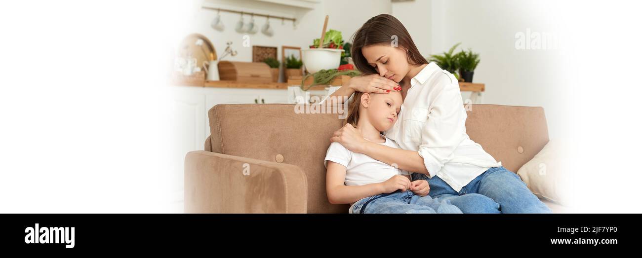A young mother supports her daughter, calms her down and strokes her ...