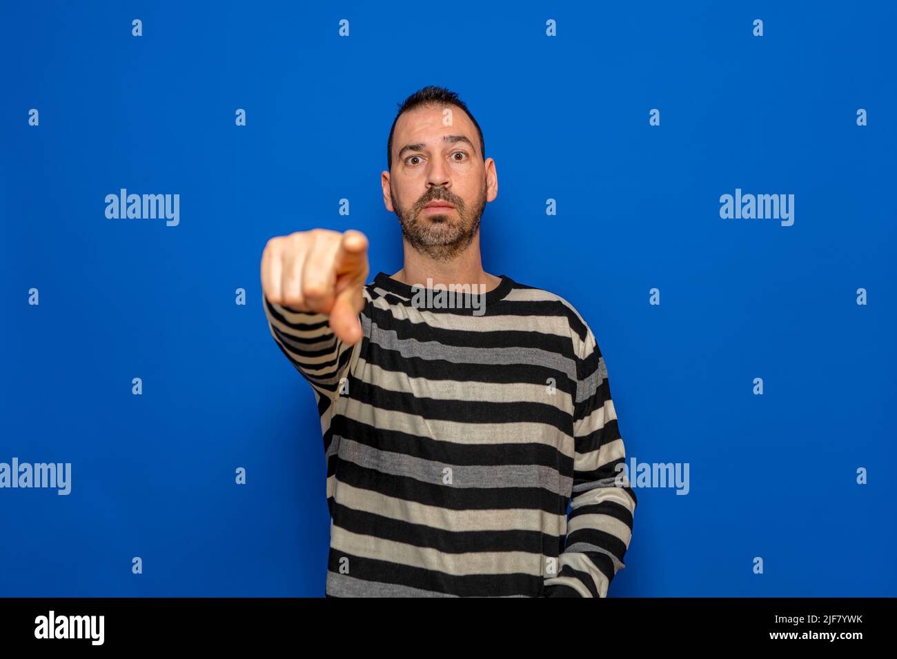 Portrait of handsome angry man pointing index finger at you on isolated ...