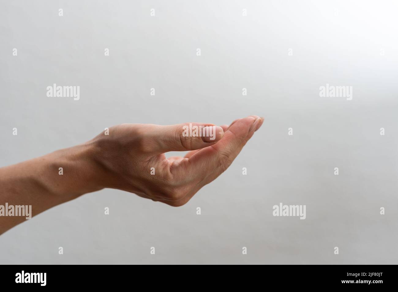 empty female woman hand holding isolated on white Stock Photo - Alamy