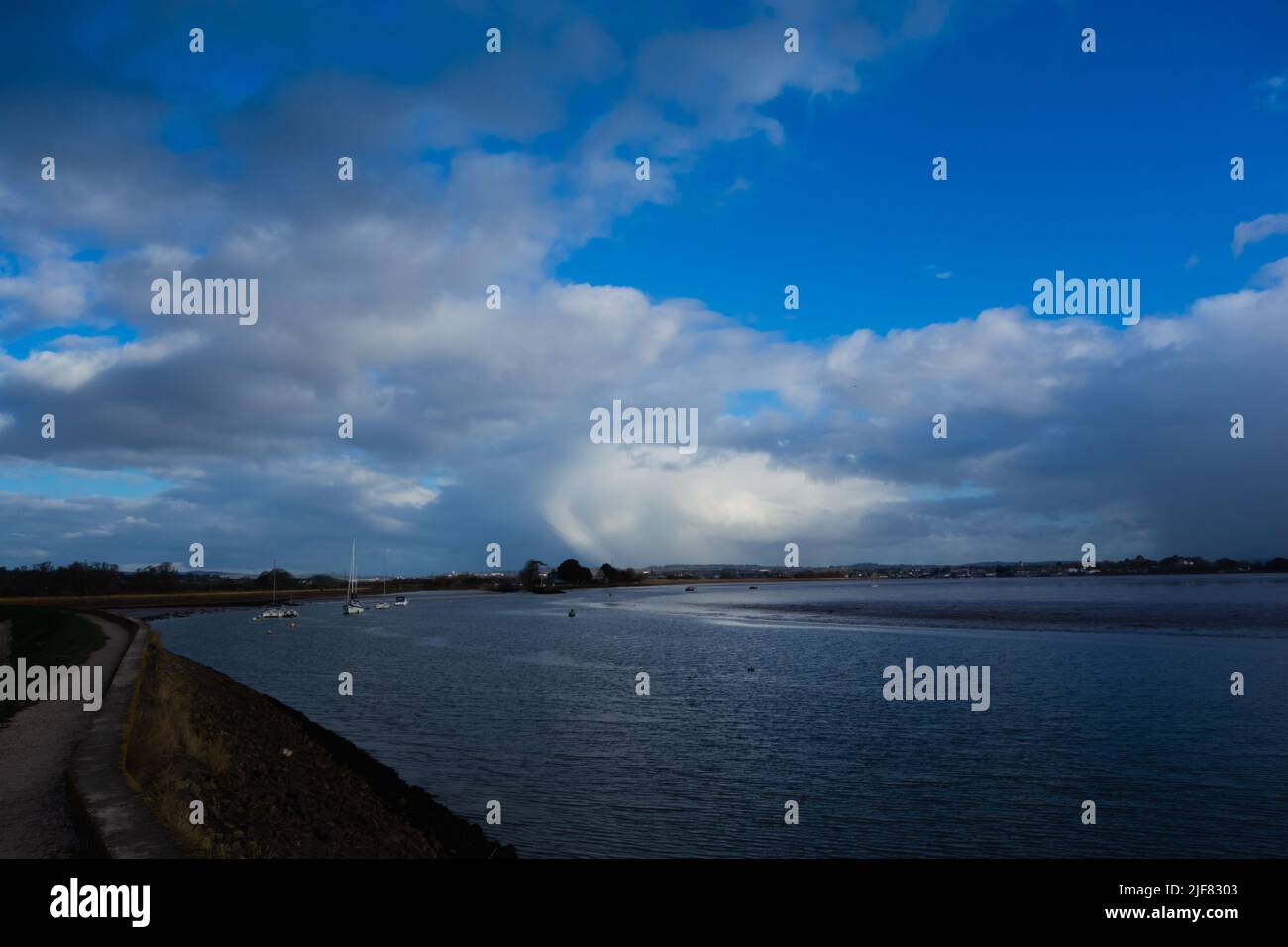 exit of the Exeter Ship Canal at Topsham with a few clouds reflected in ...