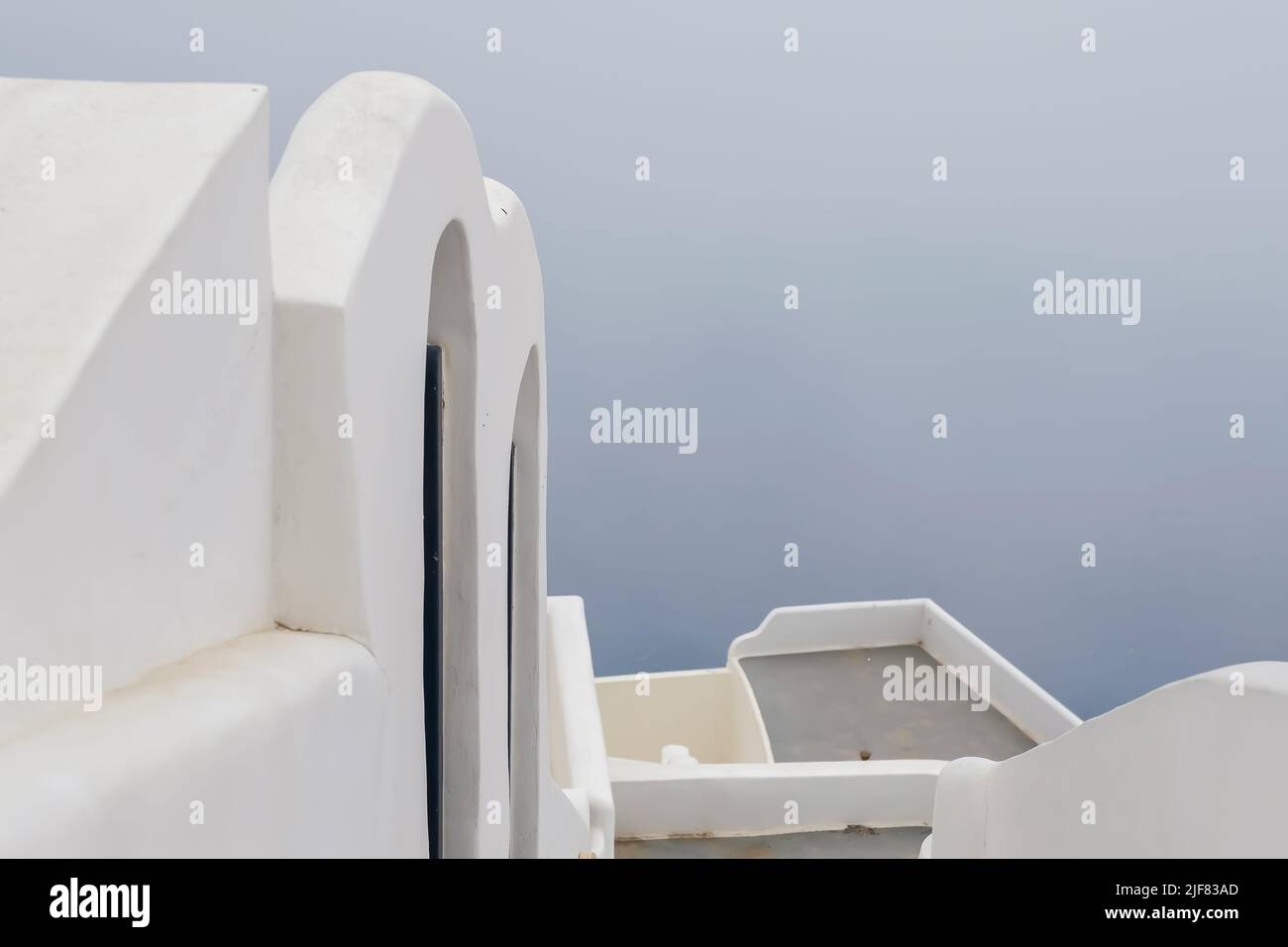 Typical whitewashed Cycladic style Villas overlooking a foggy Aegean ...