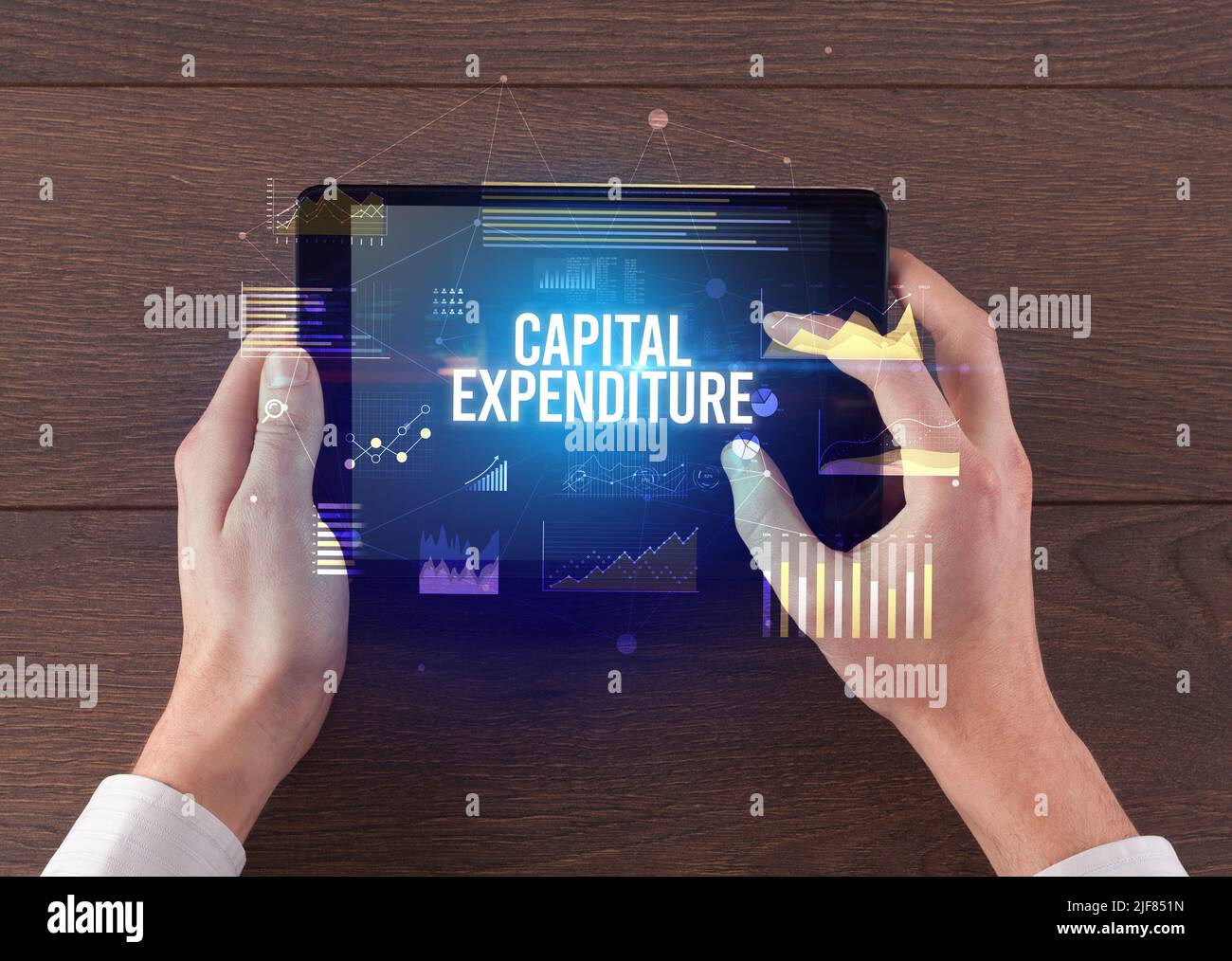 Close-up of hands holding tablet with business inscription Stock Photo ...