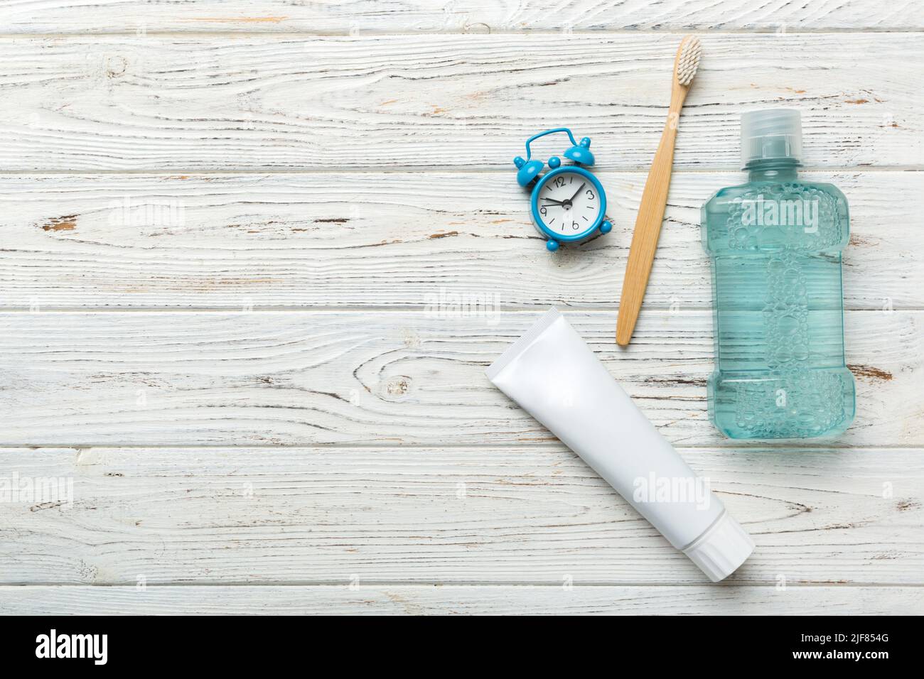 Mouthwash and other oral hygiene products on colored table top view ...