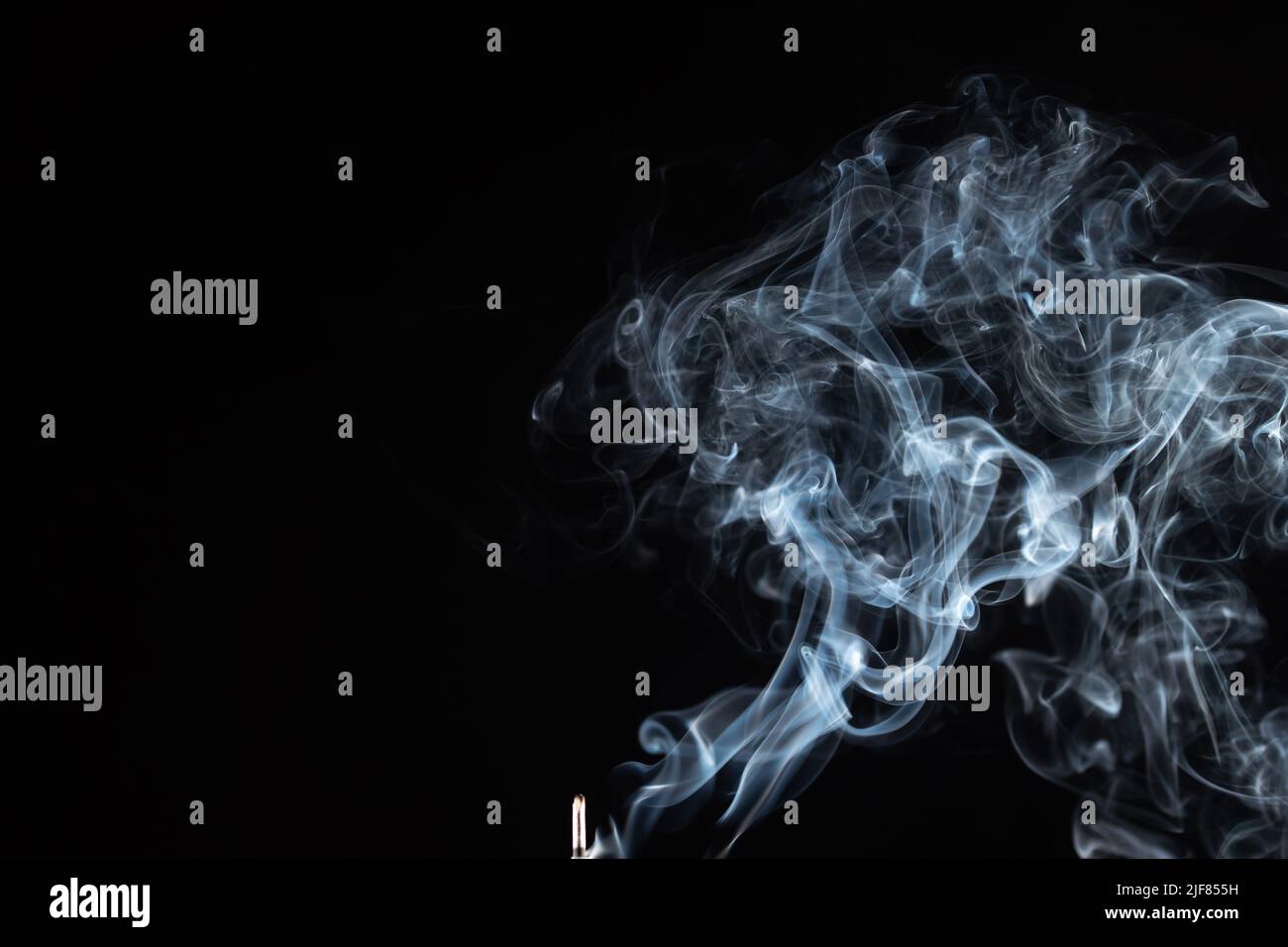 incense stick with smoke against black background Stock Photo - Alamy