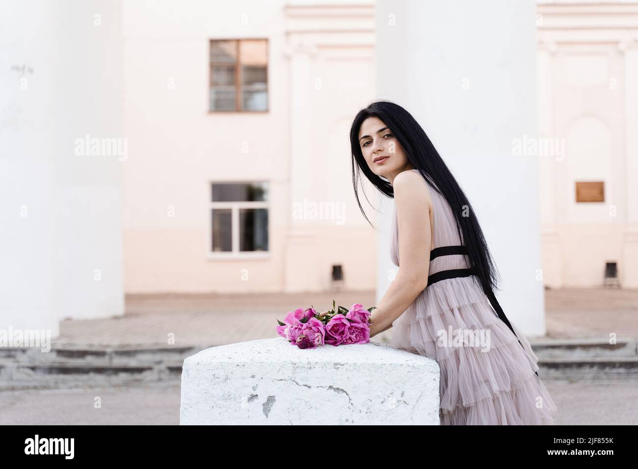 Adorable georgian woman with peonies bouquet of flowers is posing in ...