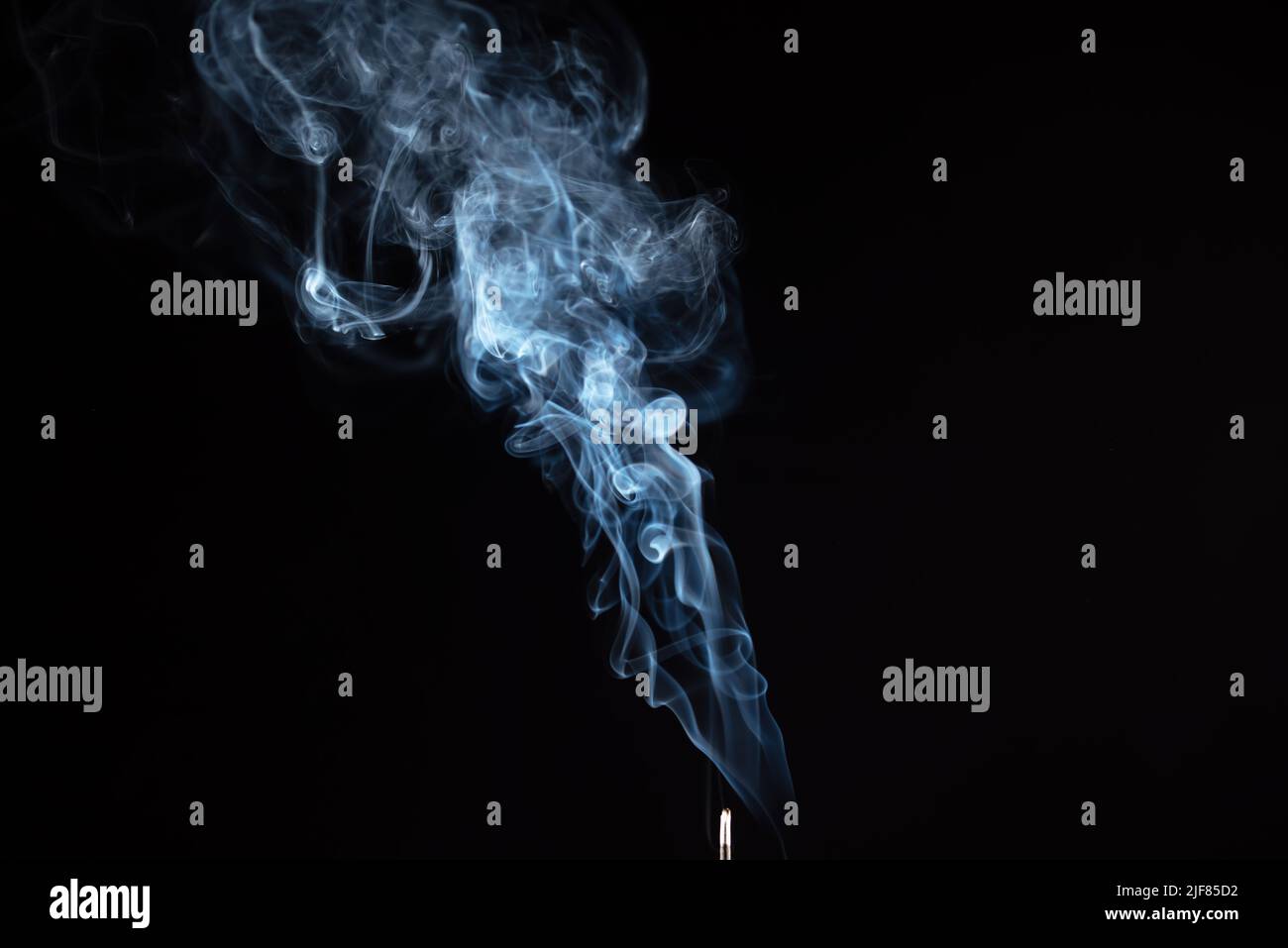 incense stick with smoke against black background Stock Photo - Alamy
