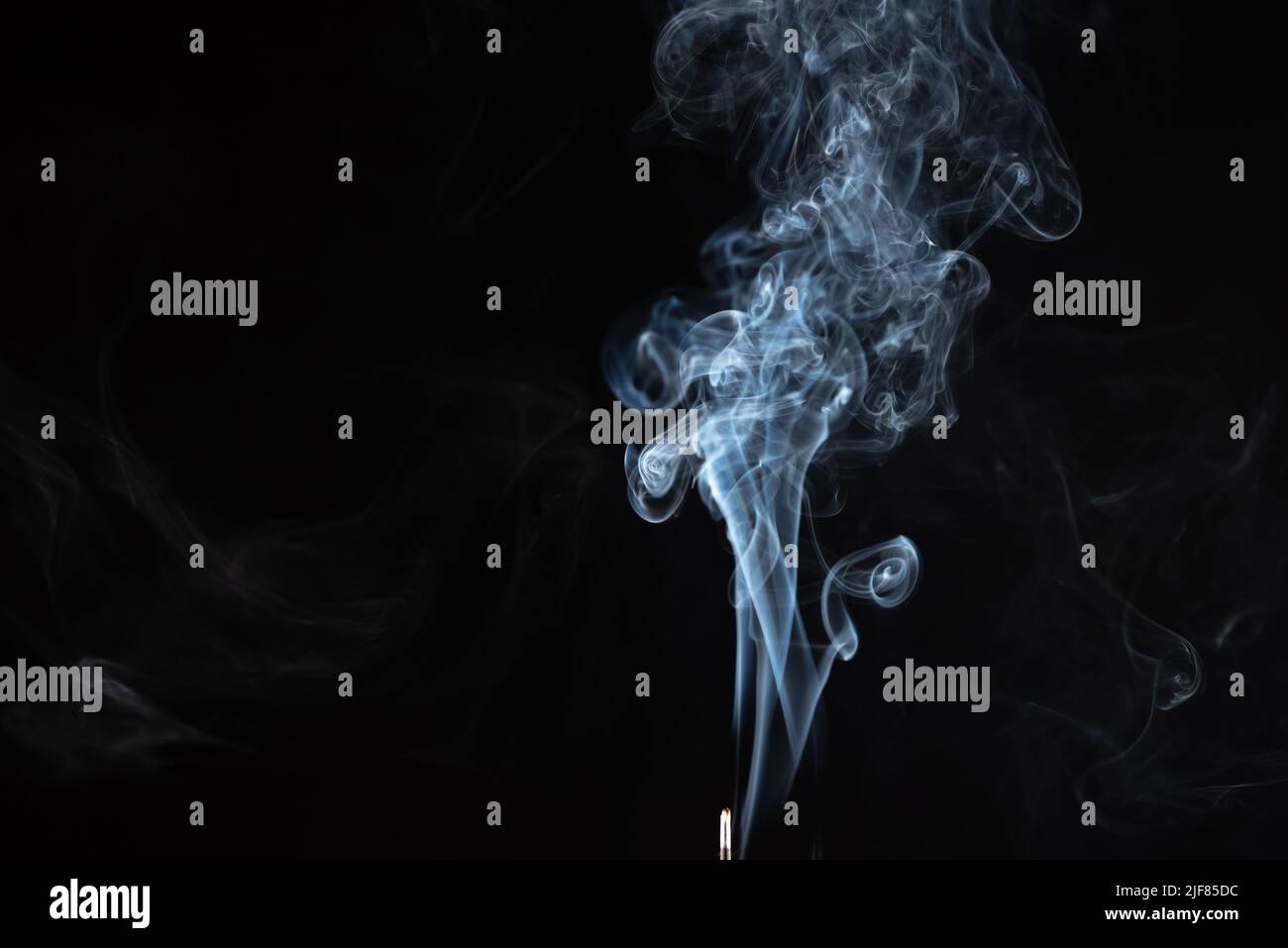 incense stick with smoke against black background Stock Photo - Alamy