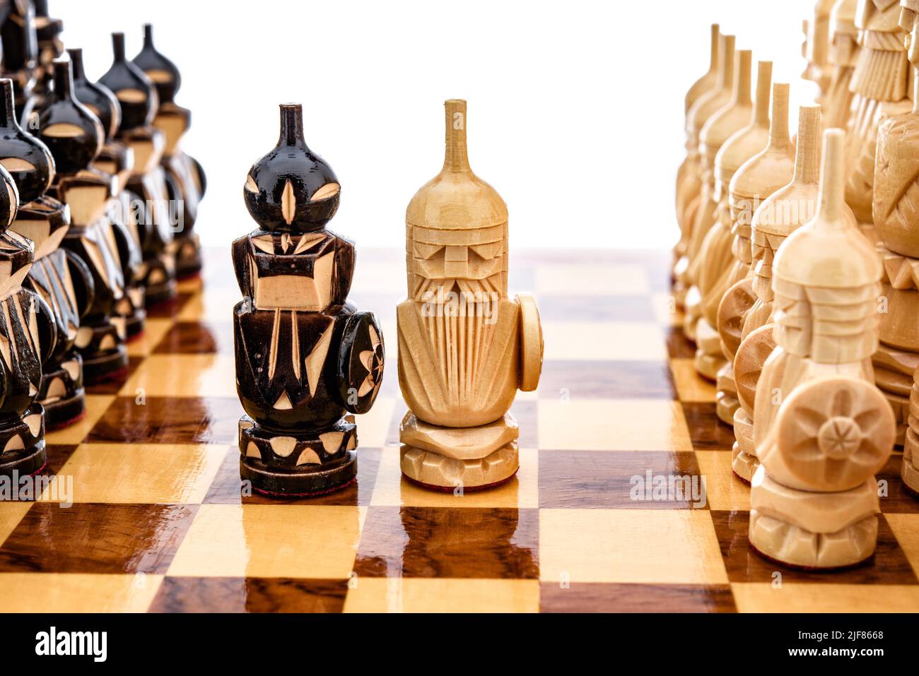 Beige Brown Wooden chess different pieces figures with carving standing ...
