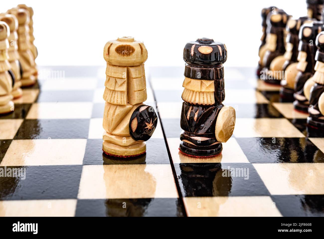 Beige Brown Wooden chess different pieces figures with carving standing ...