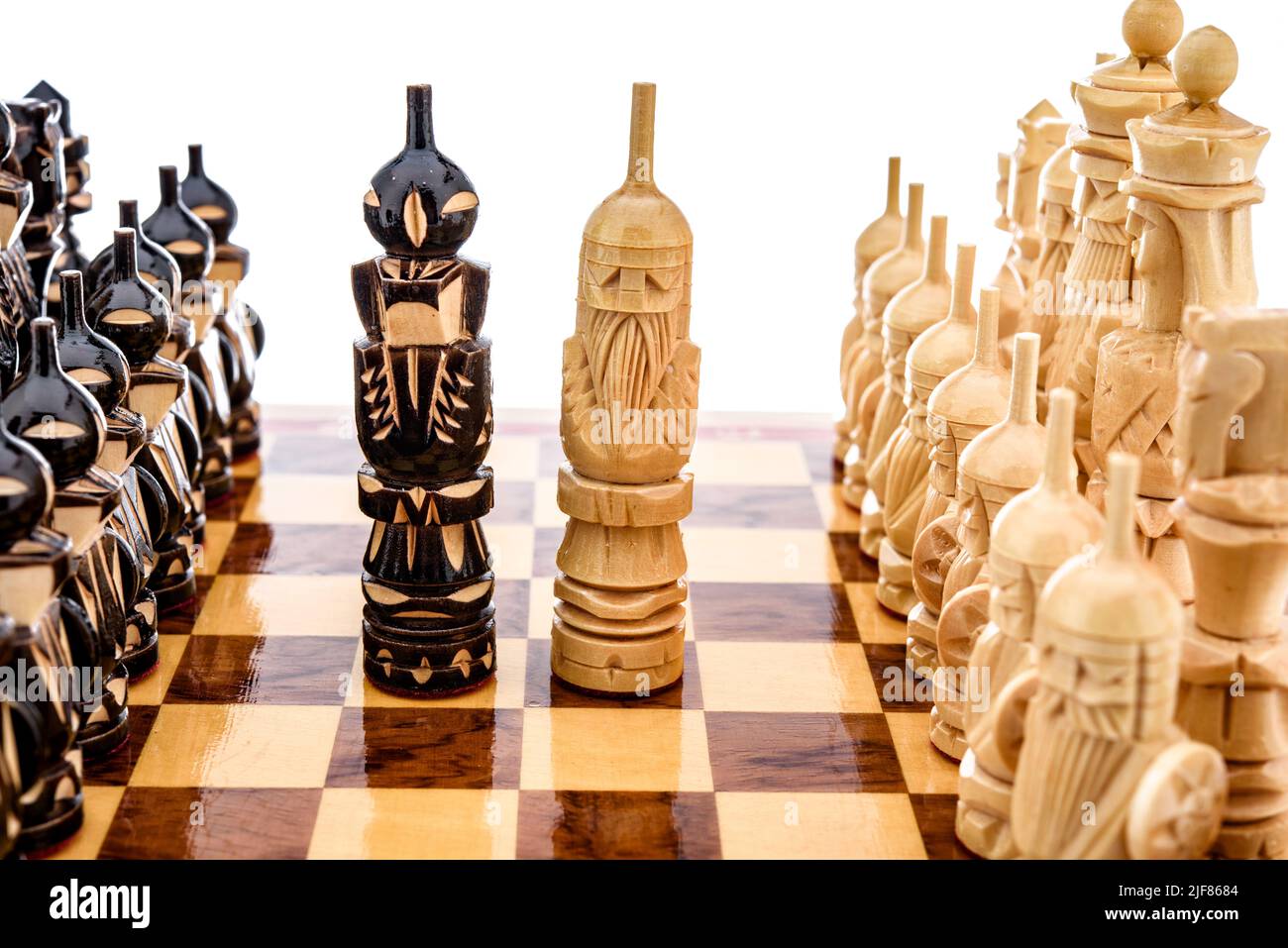 Beige Brown Wooden chess different pieces figures with carving standing ...