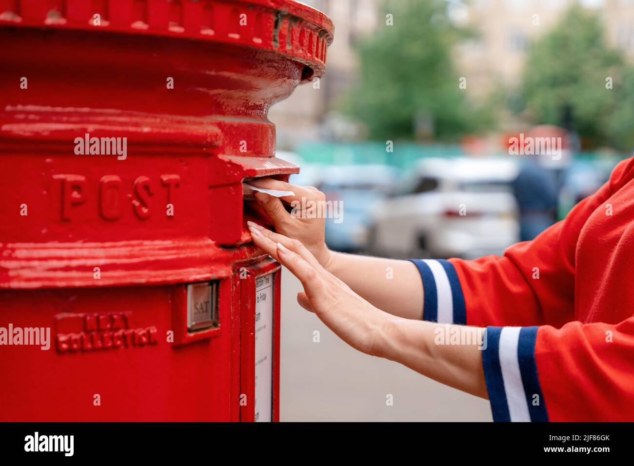 Woman posting letter in post hi-res stock photography and images - Alamy