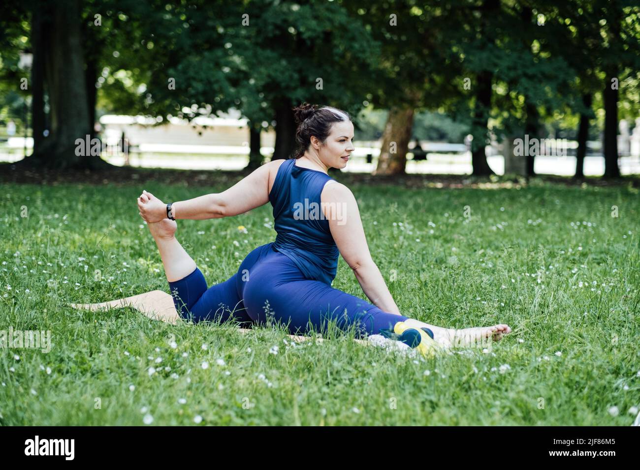 Happy confident smiling plus size curvy woman doing yoga stretching ...