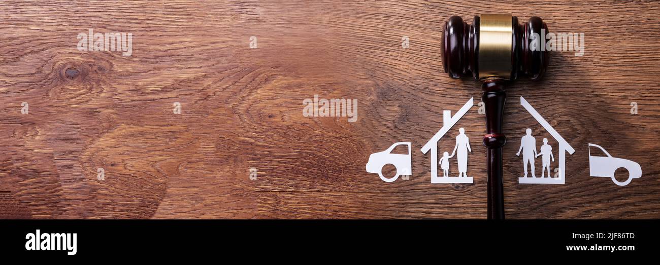 Judge Mallet Between The Split Paper Cutout Family And Car On Wooden ...