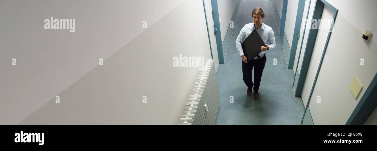 Young Man Stealing Computer Monitor Walking In Building Corridor Stock ...