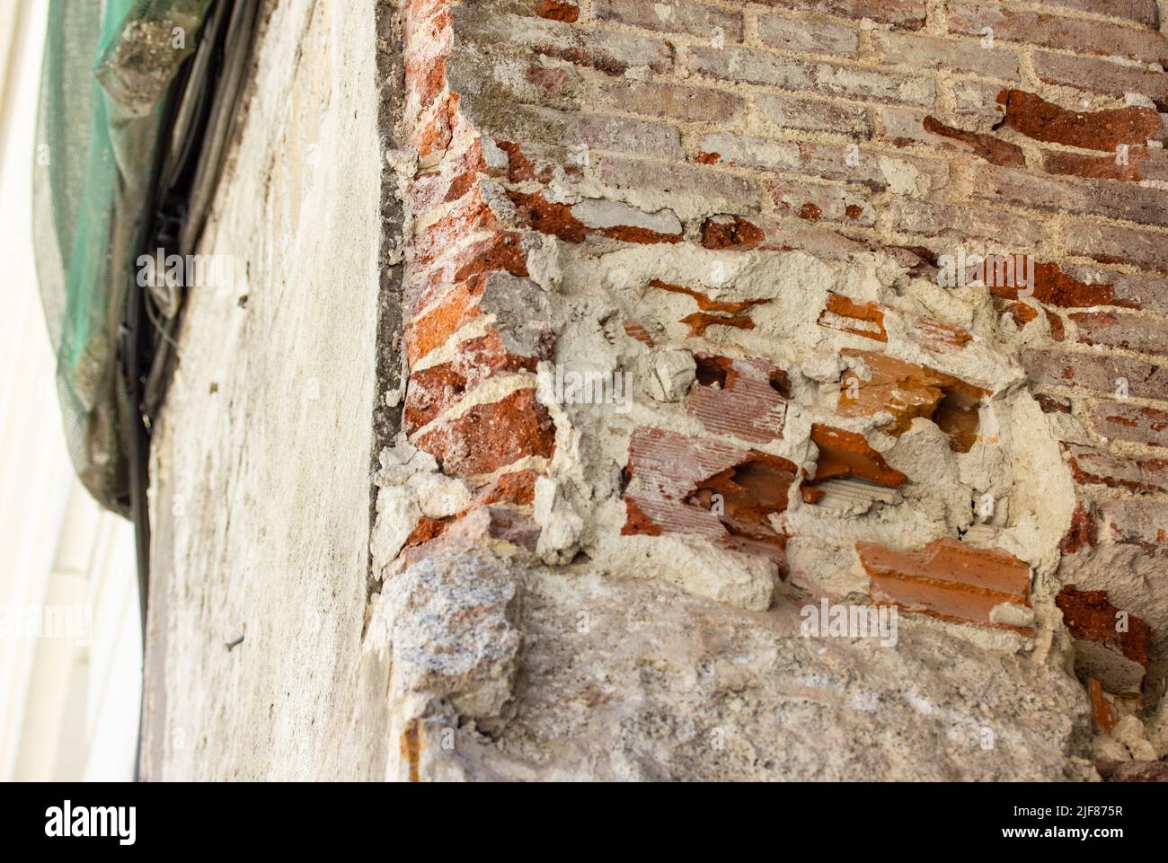 Corner of an old brick building in need of restoration, repair ...
