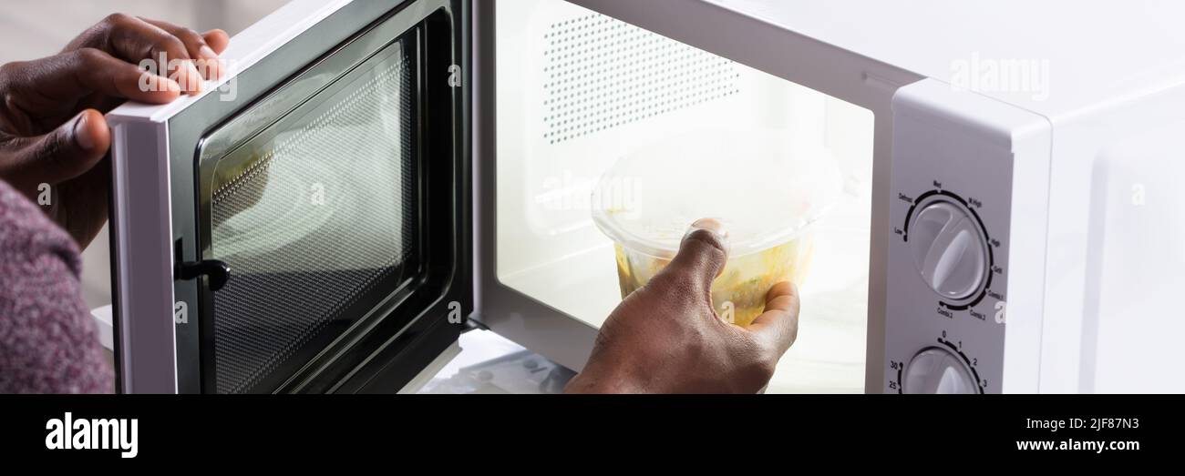 Person using microwave oven hi-res stock photography and images - Alamy