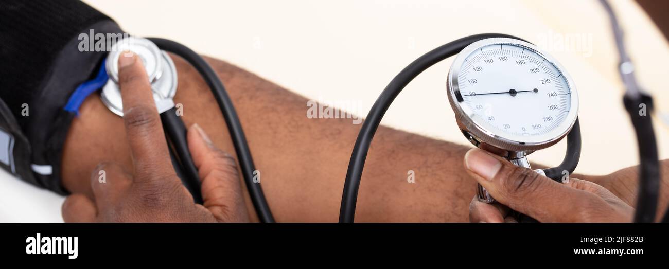 Close-up Of Doctor's Hand Measuring Blood Pressure Of Male Patient ...