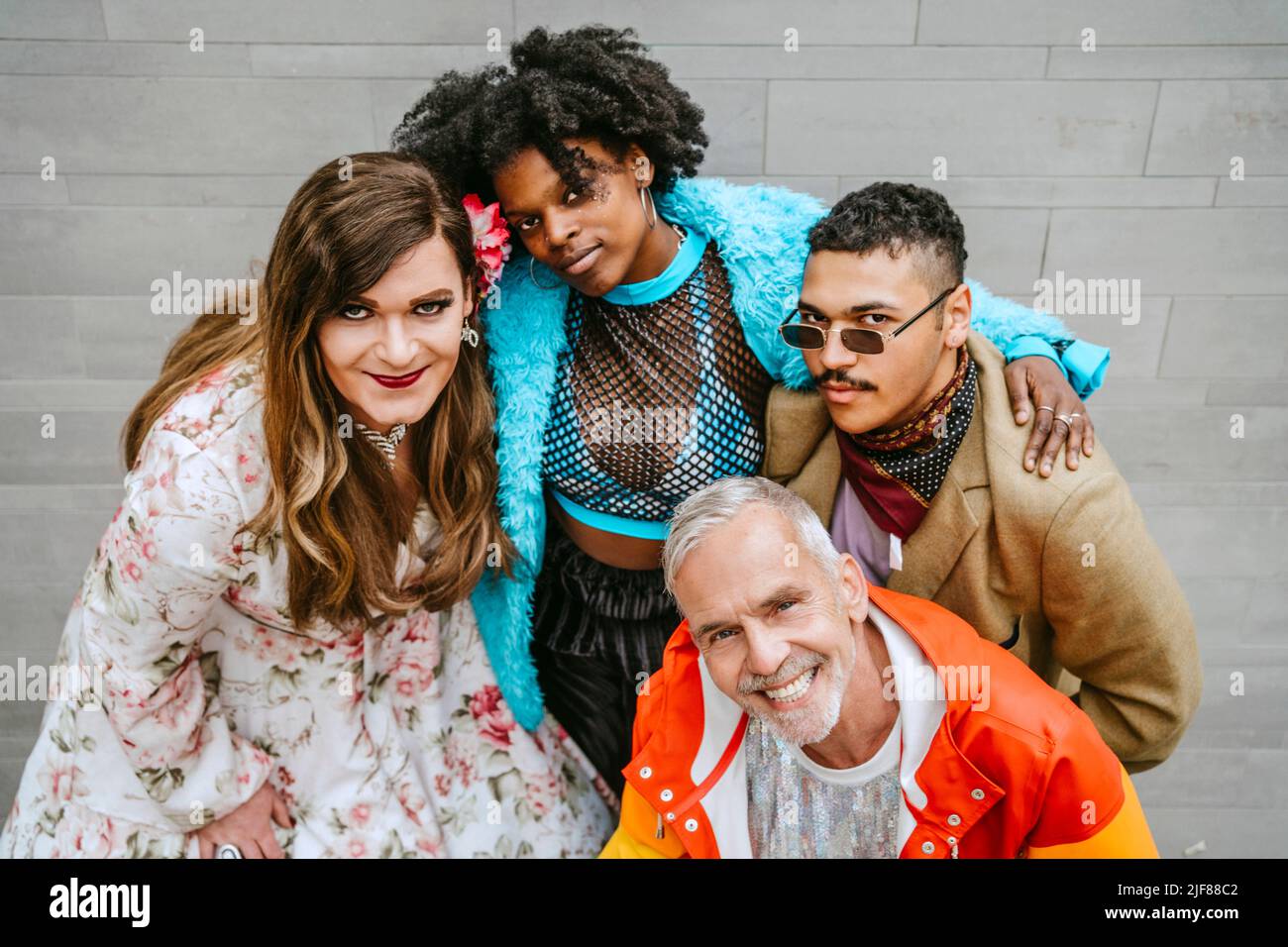 Portrait of smiling multiracial friends against wall Stock Photo - Alamy