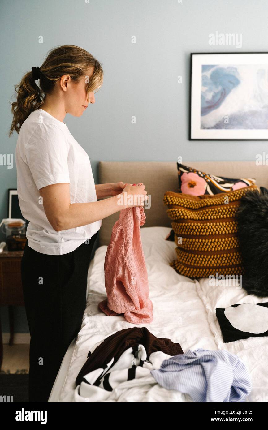Woman folding laundry folding clothes hi-res stock photography and ...