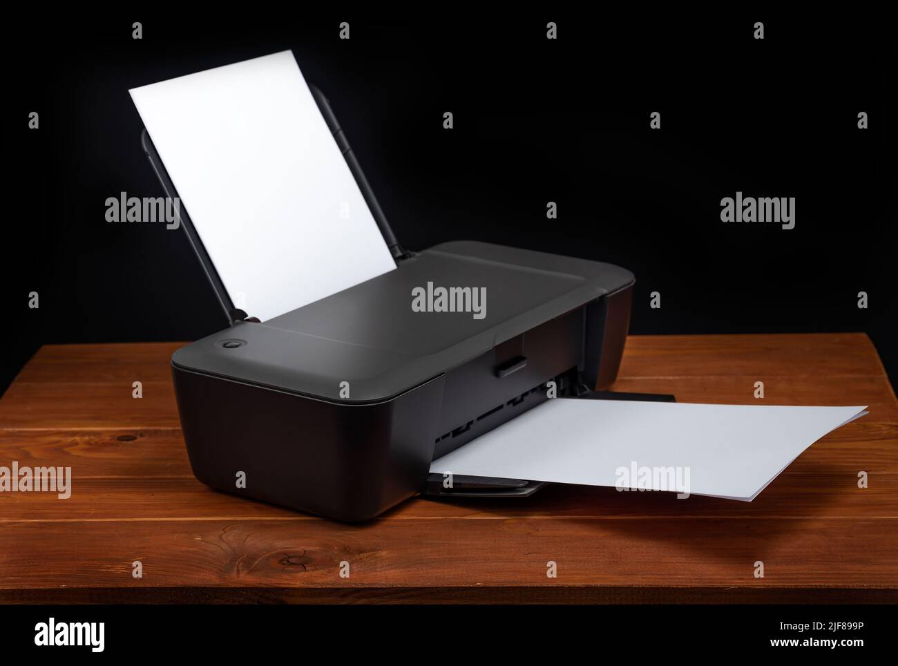 Grey InkJet printer on a wooden table and dark background Stock Photo ...