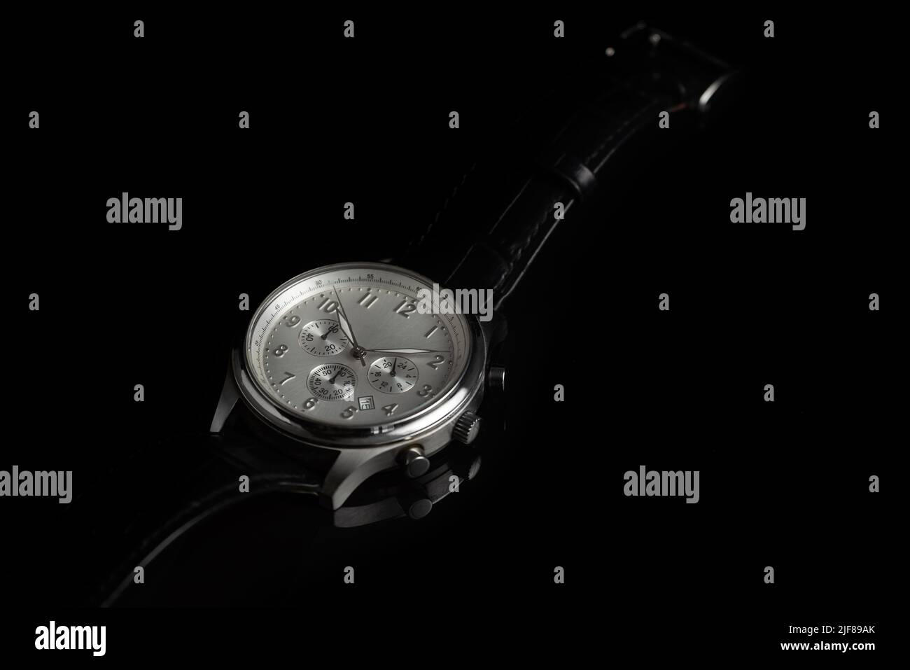 Studio shot of a silver fancy luxury unbranded Men watch on the black ...