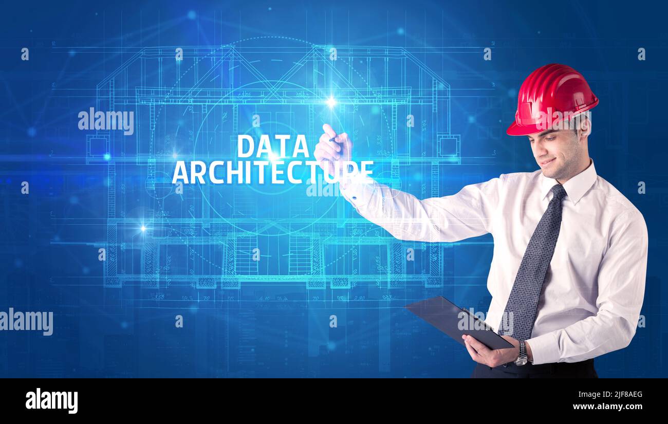 Handsome architect drawing with helmet Stock Photo - Alamy