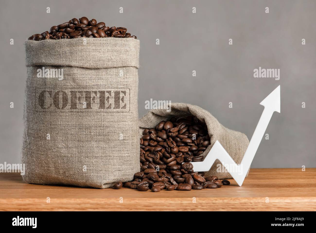 A bag of coffee beans and a chart arrow pointing up. The cost of coffee ...