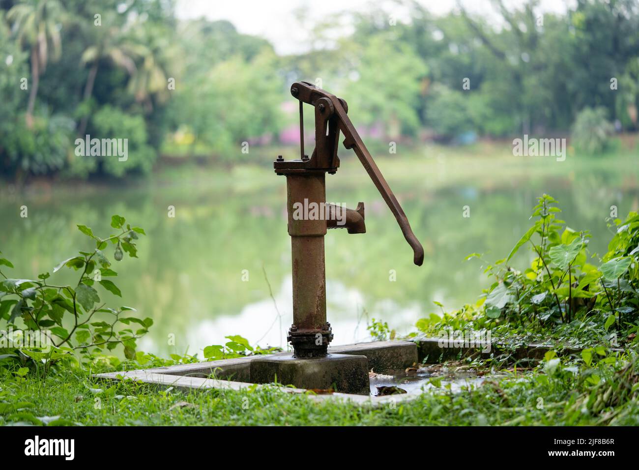 Hand operated water pump, rusted and forgotten Stock Photo - Alamy