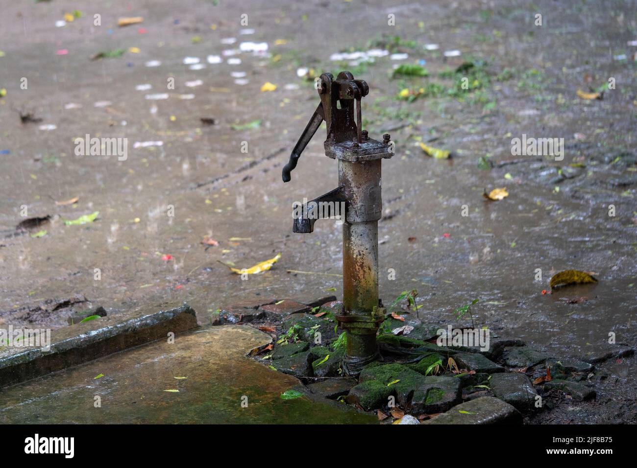 Hand operated water pump, rusted and forgotten Stock Photo - Alamy