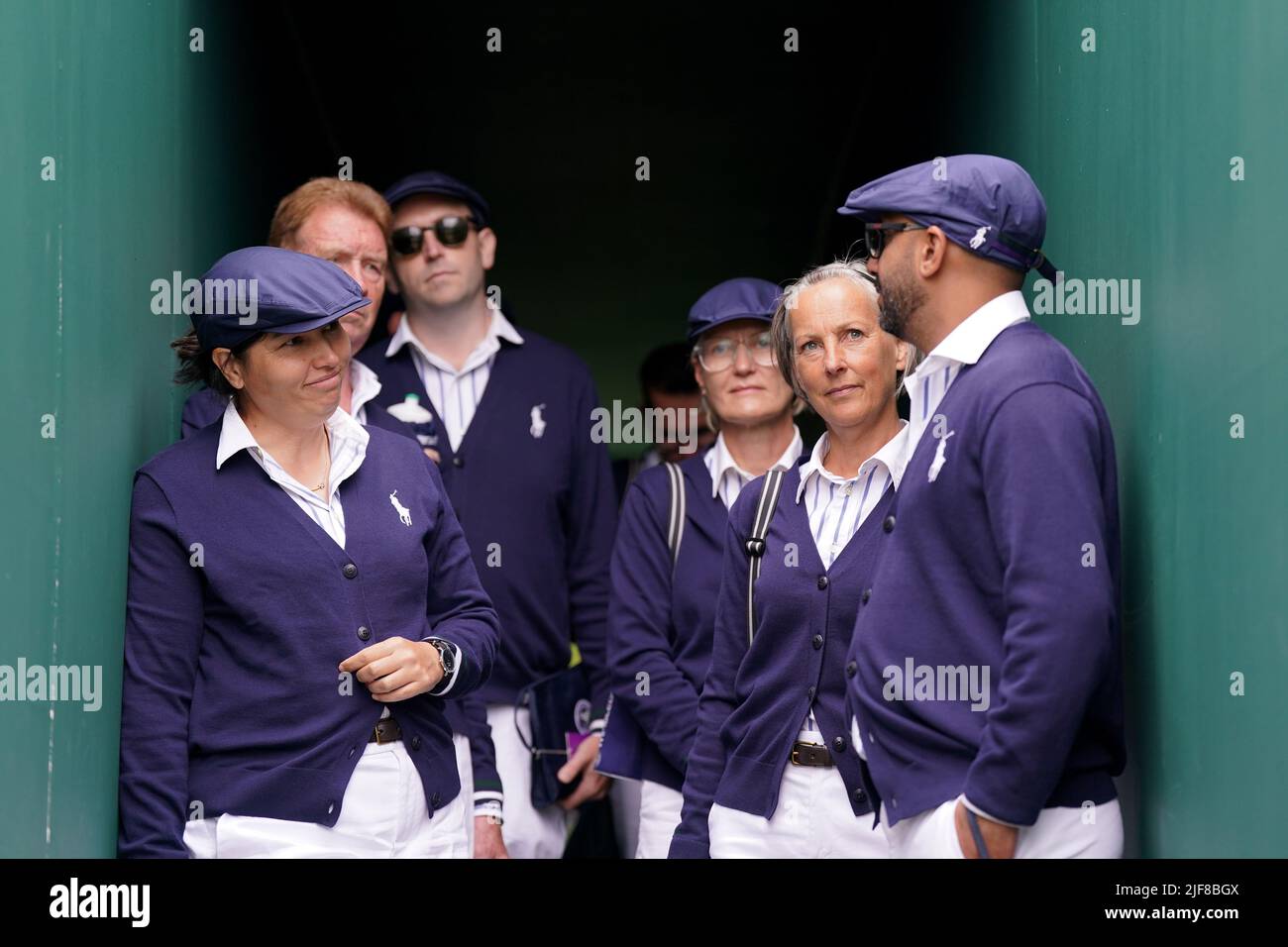 Officials wait to walk onto court during day four of the 2022 Wimbledon ...