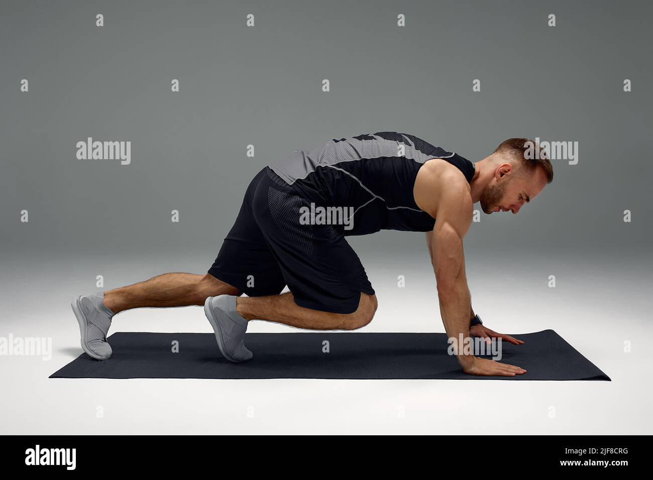 Handsome man doing plank exercise on floor indoors Stock Photo - Alamy