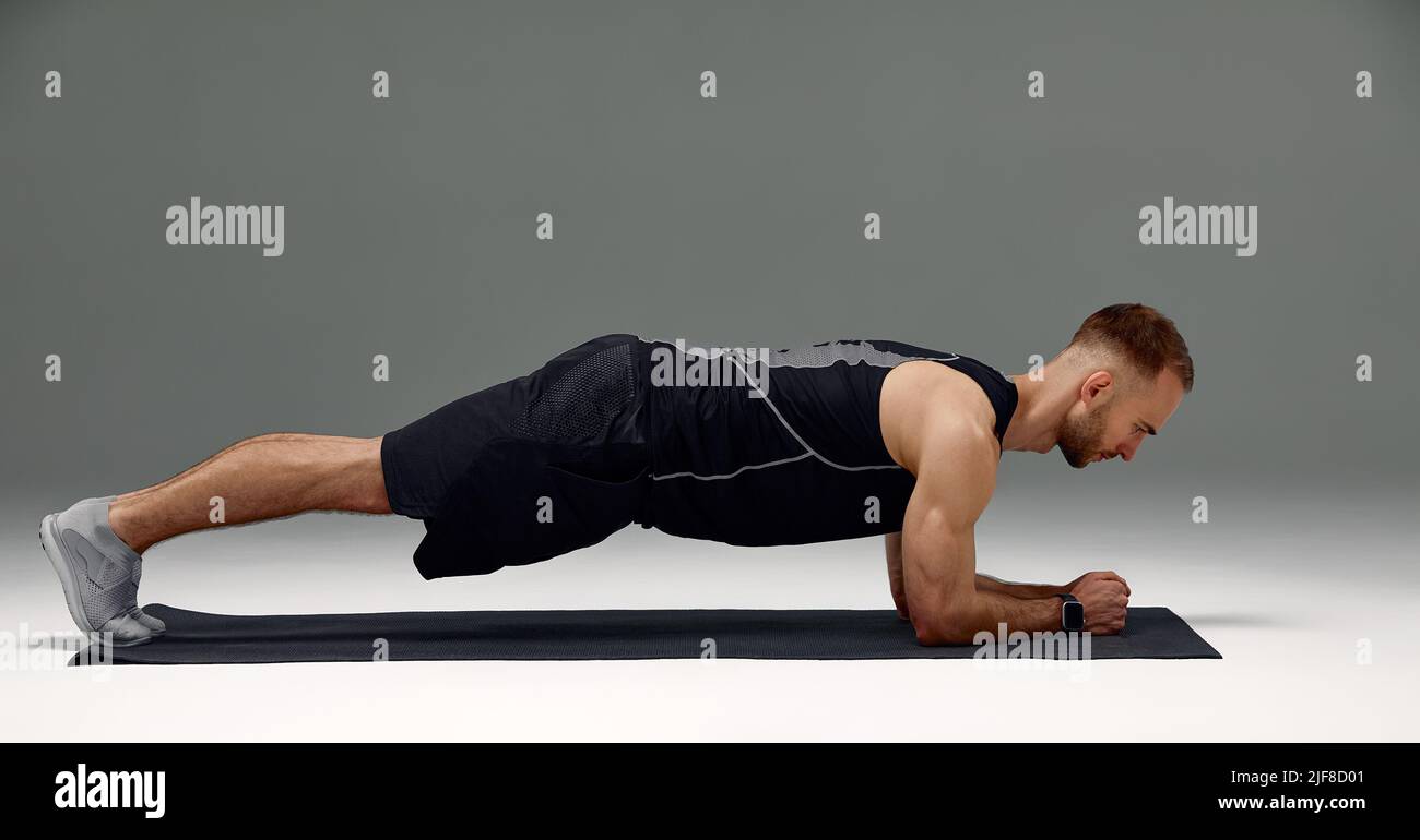 Handsome man doing plank exercise on floor indoors Stock Photo - Alamy Handsome man doing plank exercise on floor indoors Stock Photo - Alamy