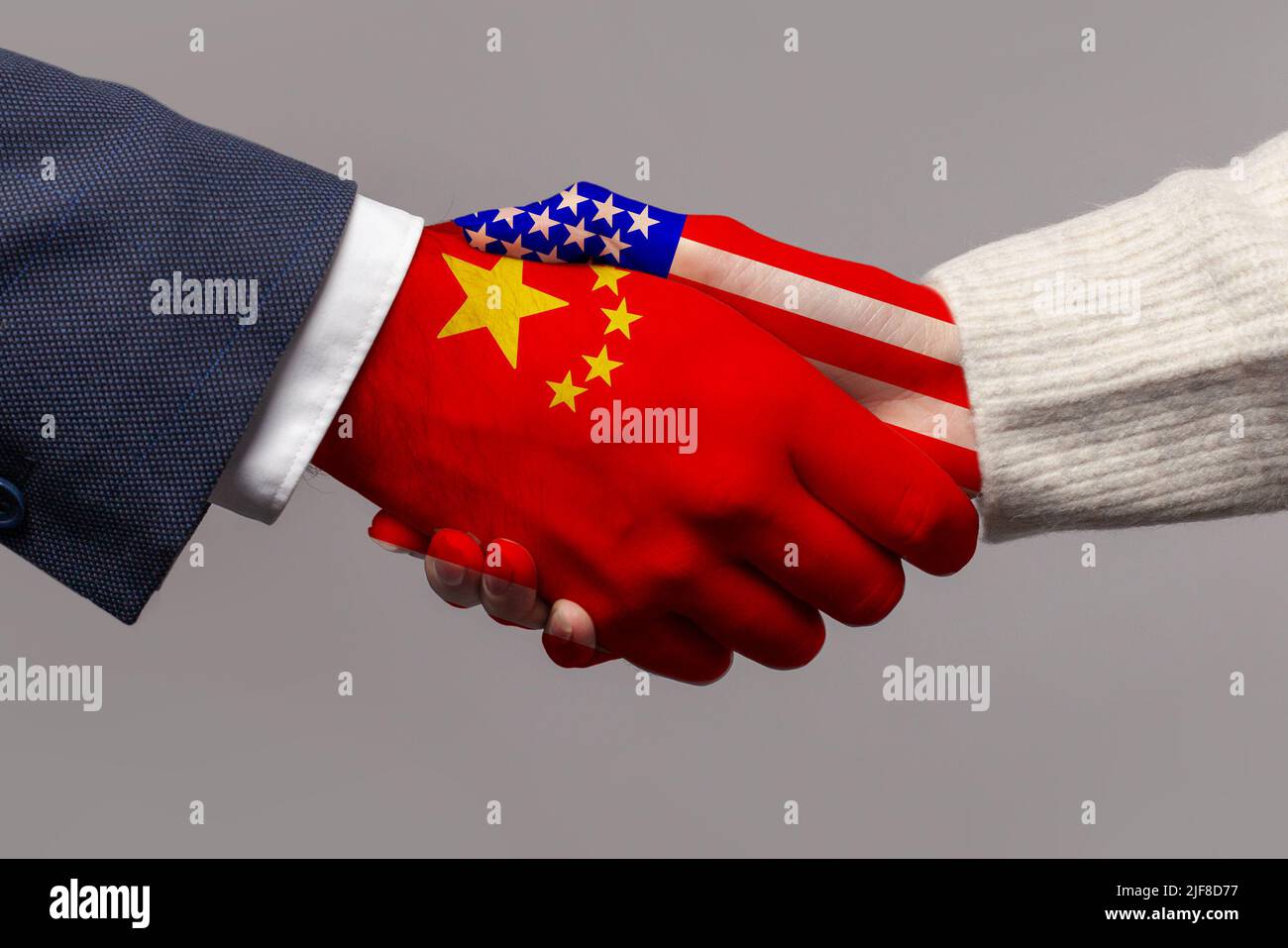 Handshake with USA and Chinese flags closeup on grey background Stock ...