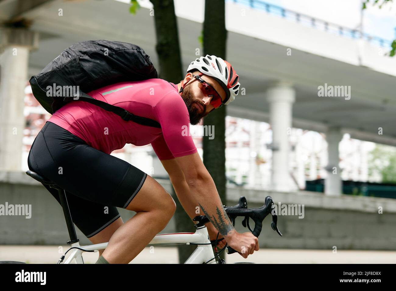 Caucasian handsome young man in protective helmet goes out for bicycle ...