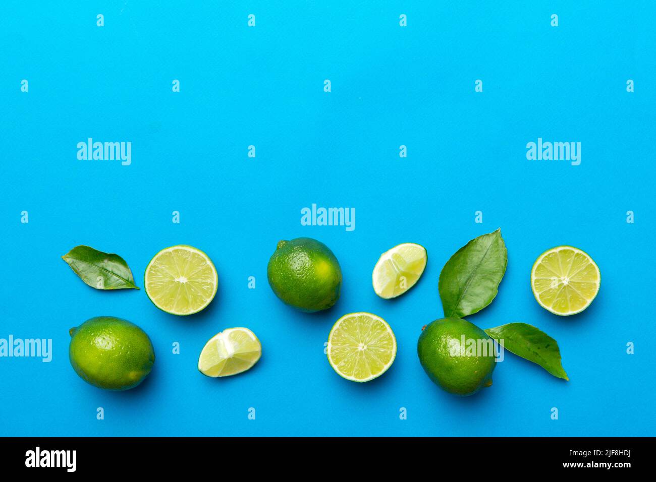 Lime fruits with green leaf and cut in half slice isolated on white ...