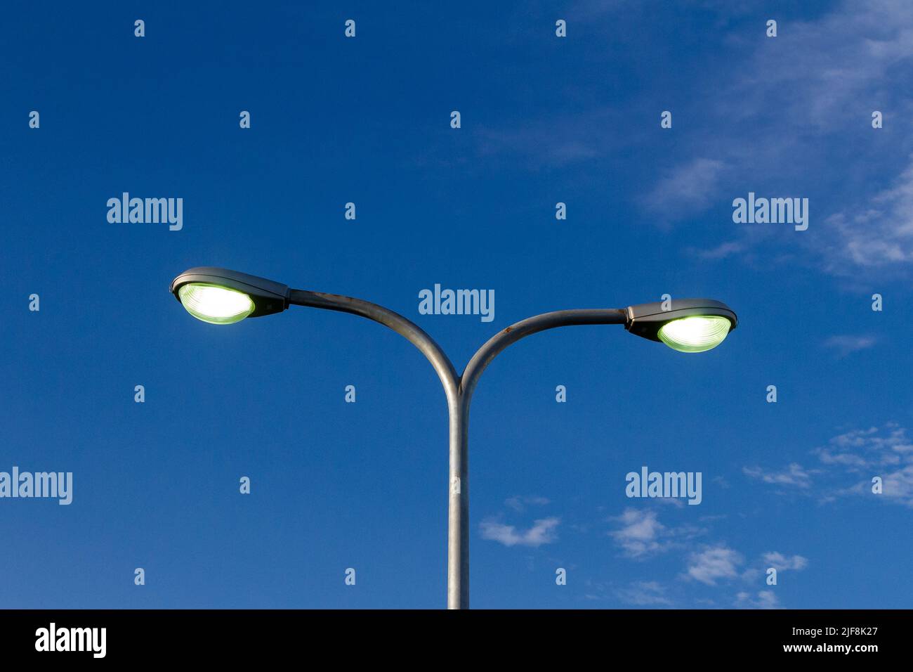 A street light paired from a single upright pole Stock Photo - Alamy