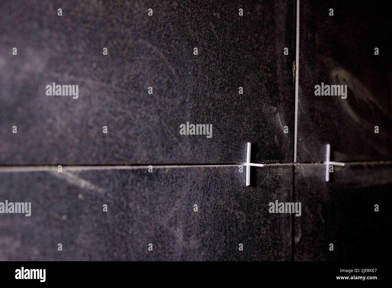 Laying ceramic tiles on a special cement mortar with the help of ...