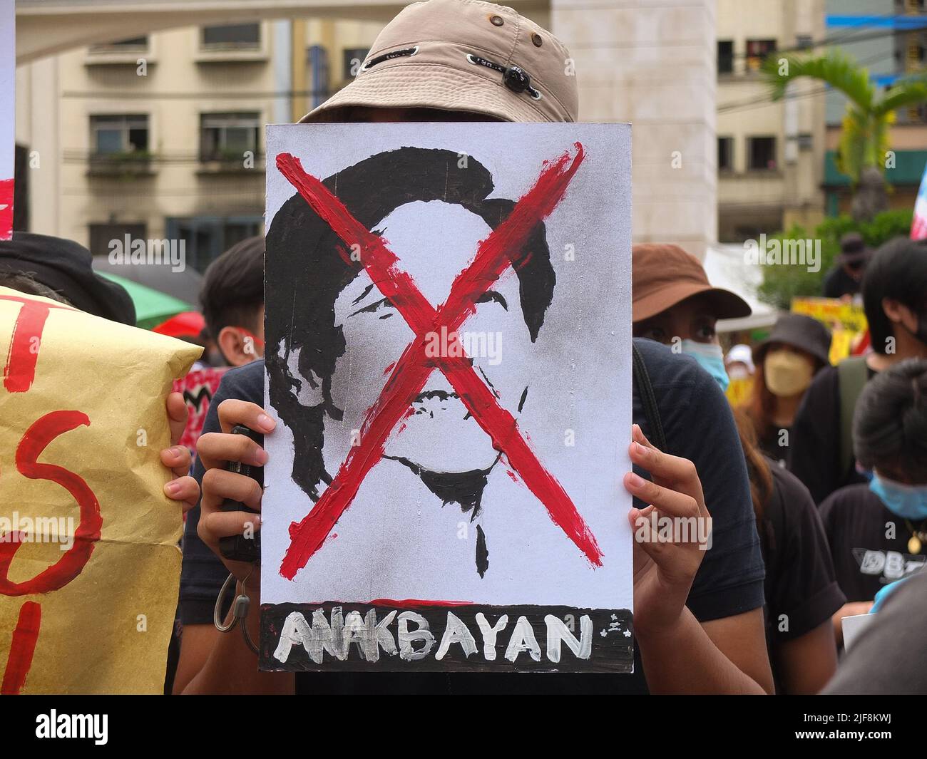 Manila, Philippines. 30th June, 2022. A protester holds a face ...