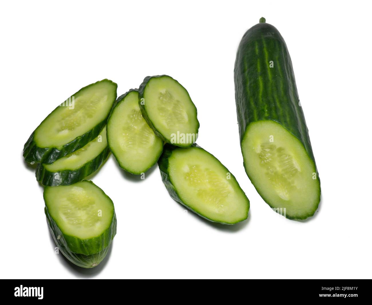 Smooth medium-sized cucumber on a white background. Cucumber slices ...