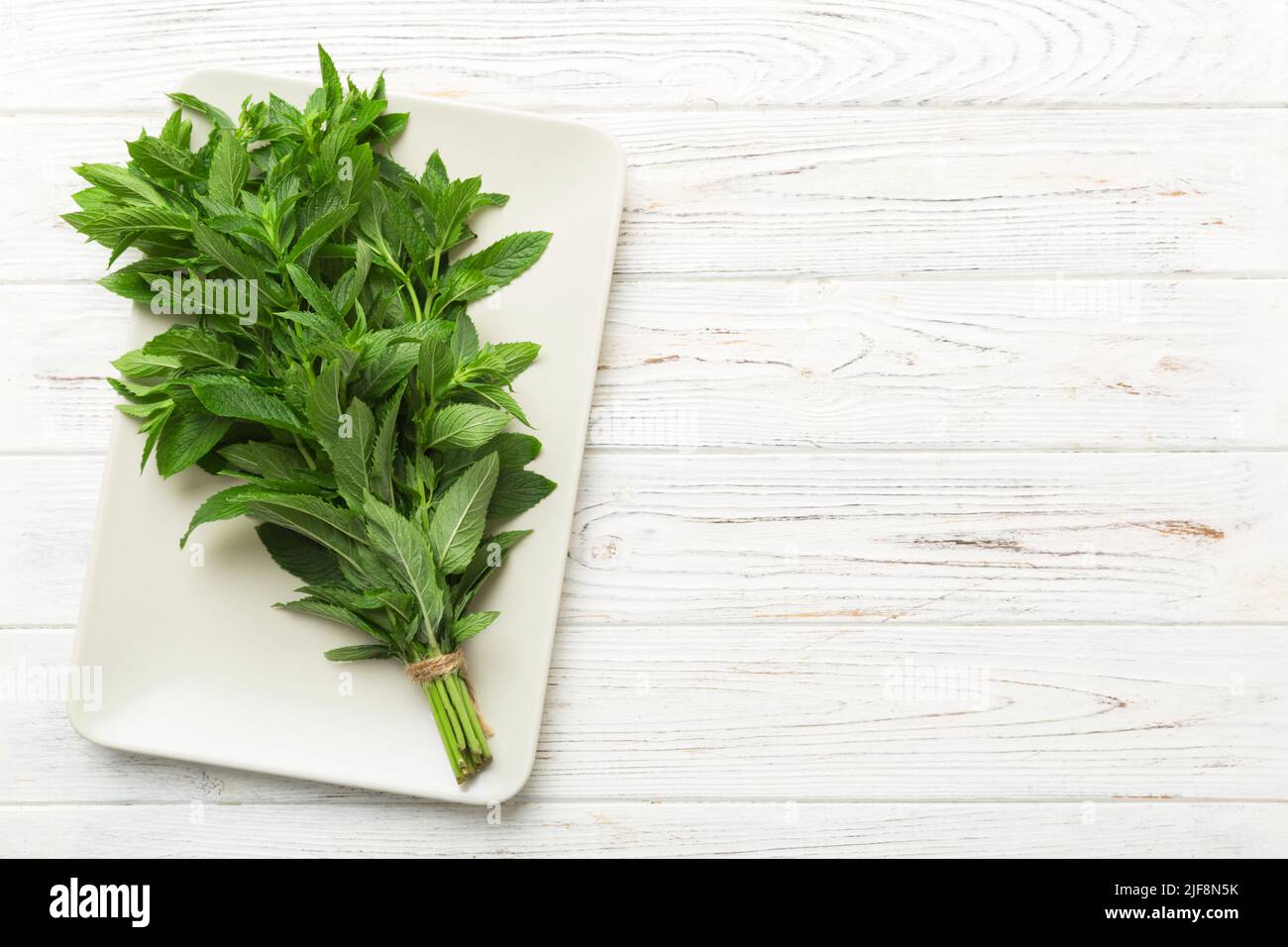 Fresh mint bunch on colored table. Top view with copy space Stock Photo ...