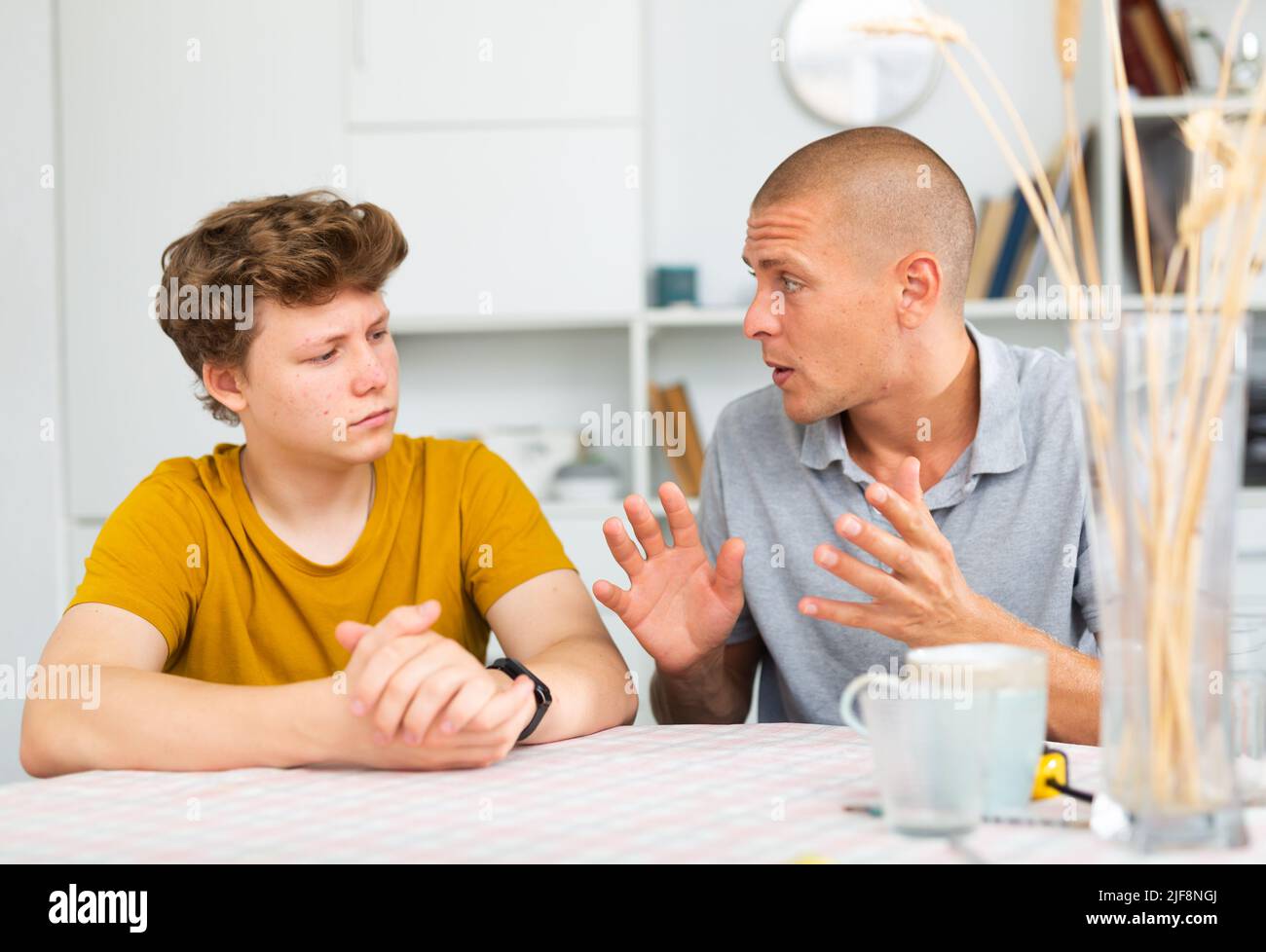 Sit-down conversation of dad and son Stock Photo - Alamy