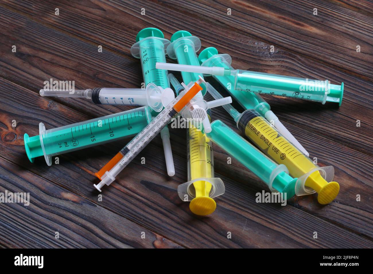 Top view of a pile of syringes and insulin syringes ready for injection ...