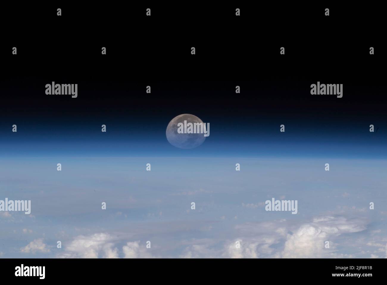As the Moon sets below Earth's horizon the atmosphere refracts, or ...
